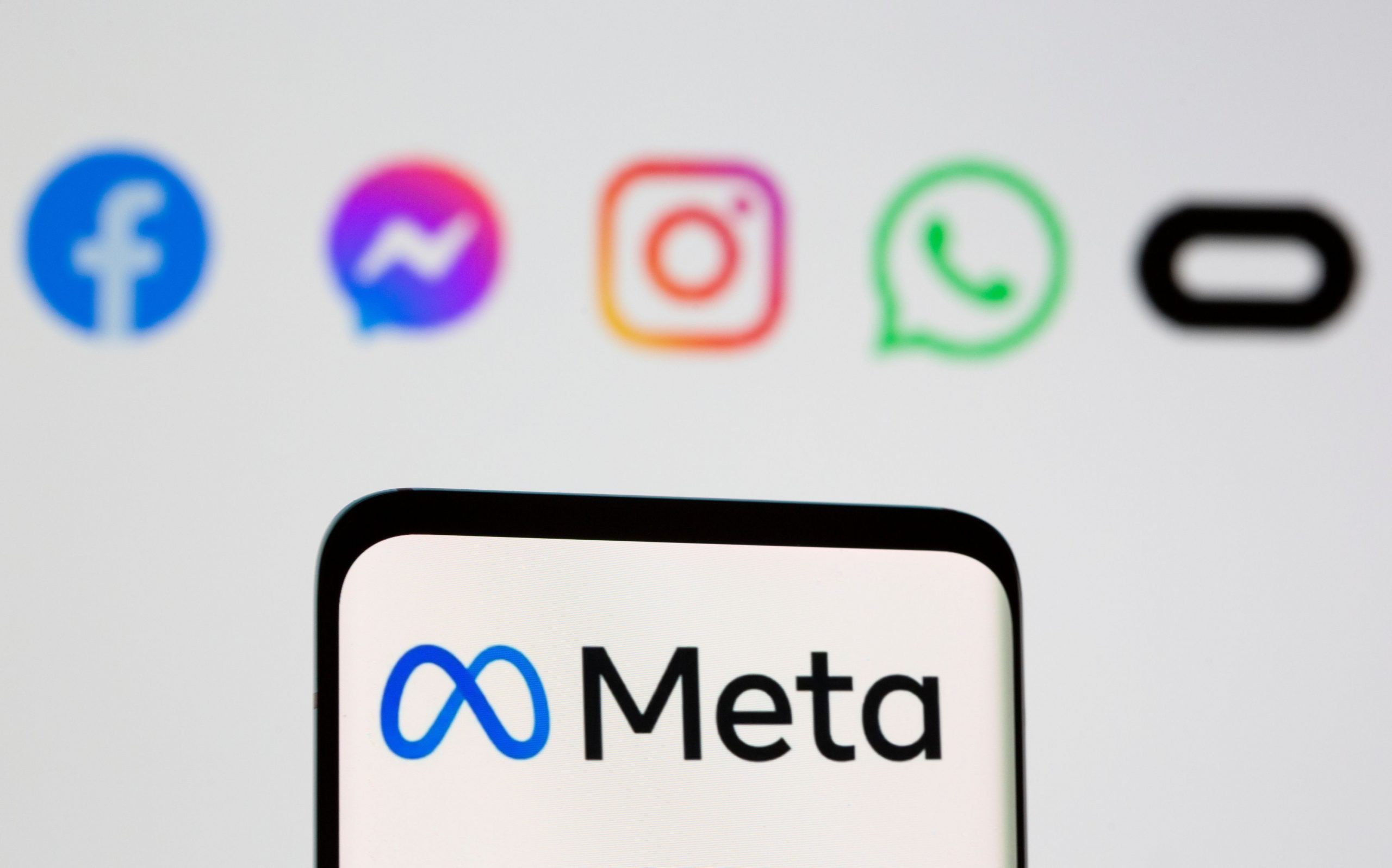 Facebook's new rebrand logo Meta is seen on smartpone in front of ...